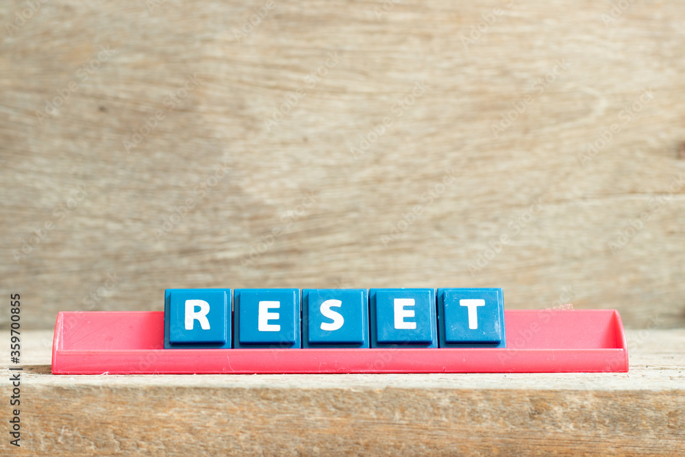 Tile letter on red rack in word reset on wood background Stock Photo ...