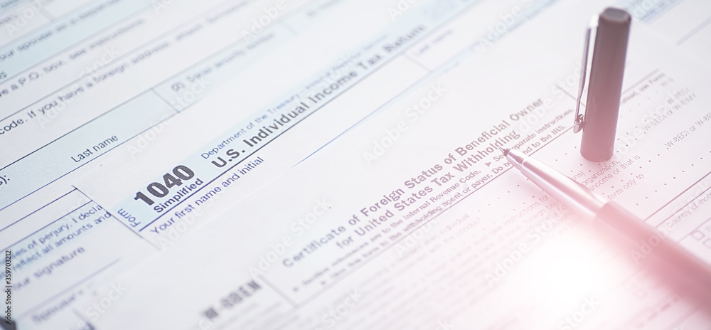 Annual tax reporting. Tax form on the table. Financial statements for ...