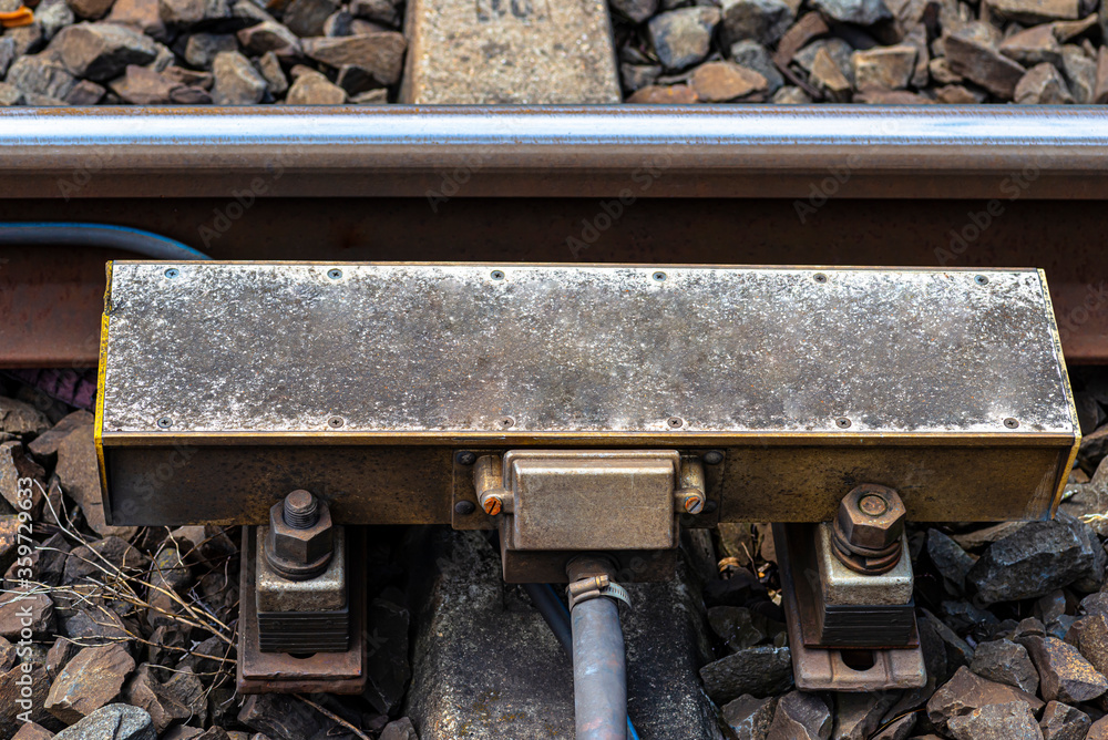 Automatic train braking system mounted on railway tracks, visible ...
