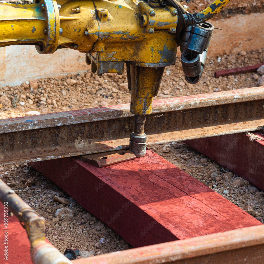 Railway workers bolting track rail. Detail worker with Light portable ...