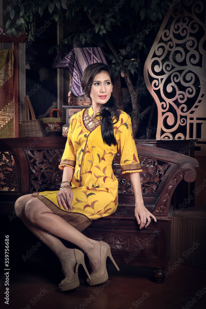 beautiful woman wearing an elegant batik dress, Batik is a fabric that ...