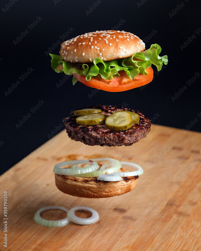 Classic Burger. The components of the Burger are flying in the air on a ...