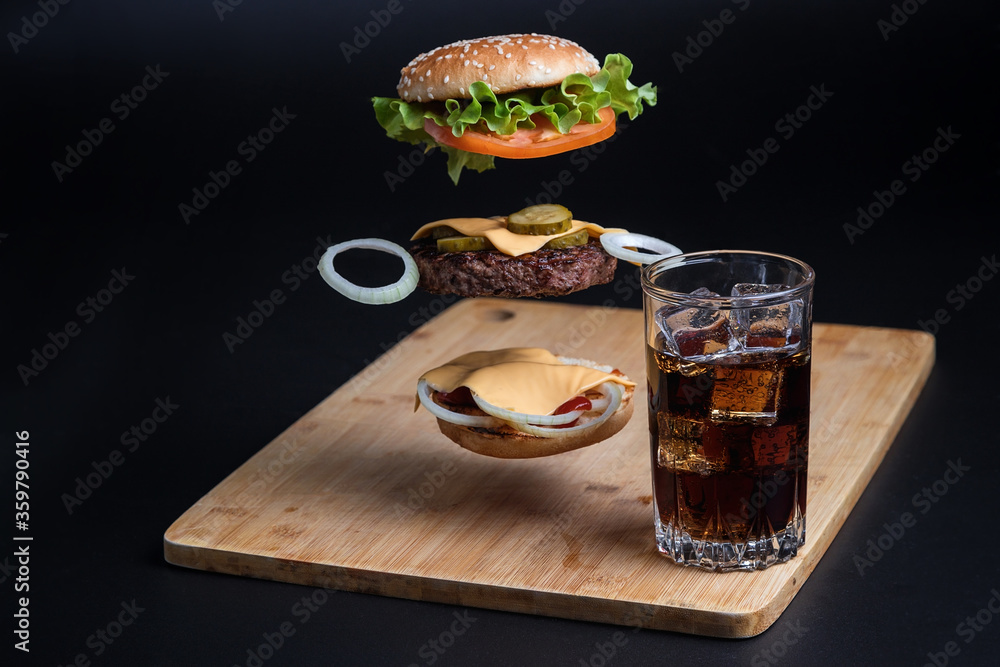 Classic Burger. Still life of a Burger and coke. Drink in a tall glass ...