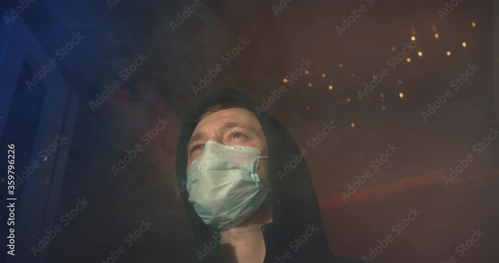 Guy in mask stand after fire apartment. Chemical sanitizer steam ...