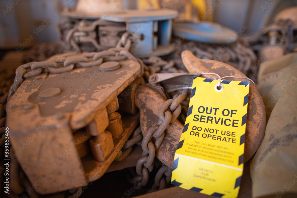 Safety workplaces yellow out of service tag attached on faulty damage ...