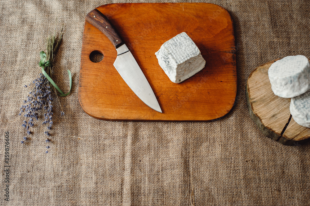 Valencay cheese on a wooden the board. French goat's milk cheese is ...