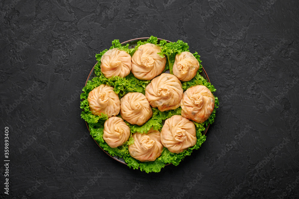 Veg Momos on black slate table top. Momos is the popular dish of indian ...
