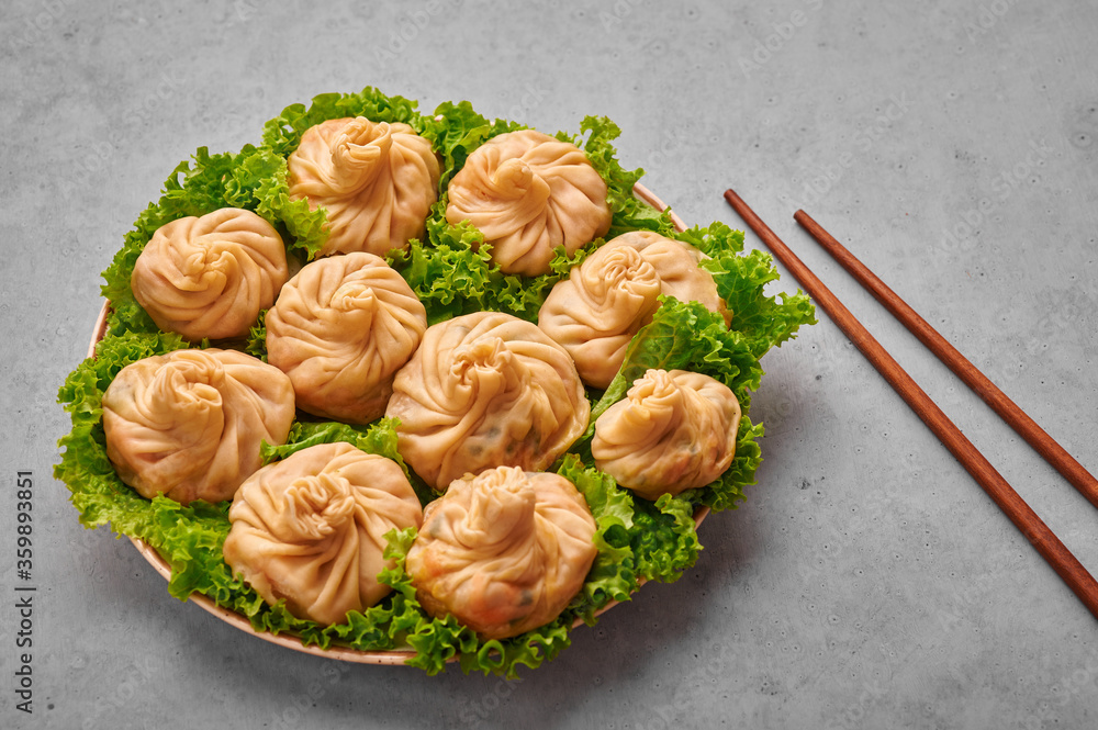 Veg Momos on gray concrete table top . Momos is the popular dish of ...