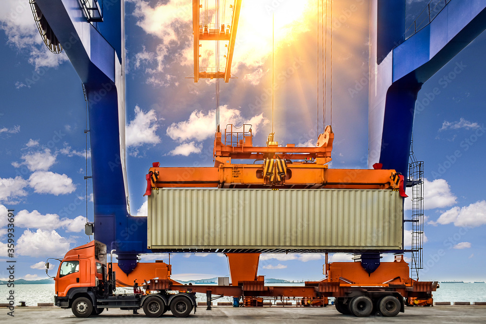 Quay crane lifting up 40 feets container from trailer using spreader at ...