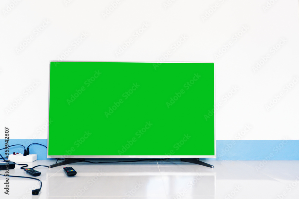 smart TV with green screen on tile floor of living room of house Stock ...