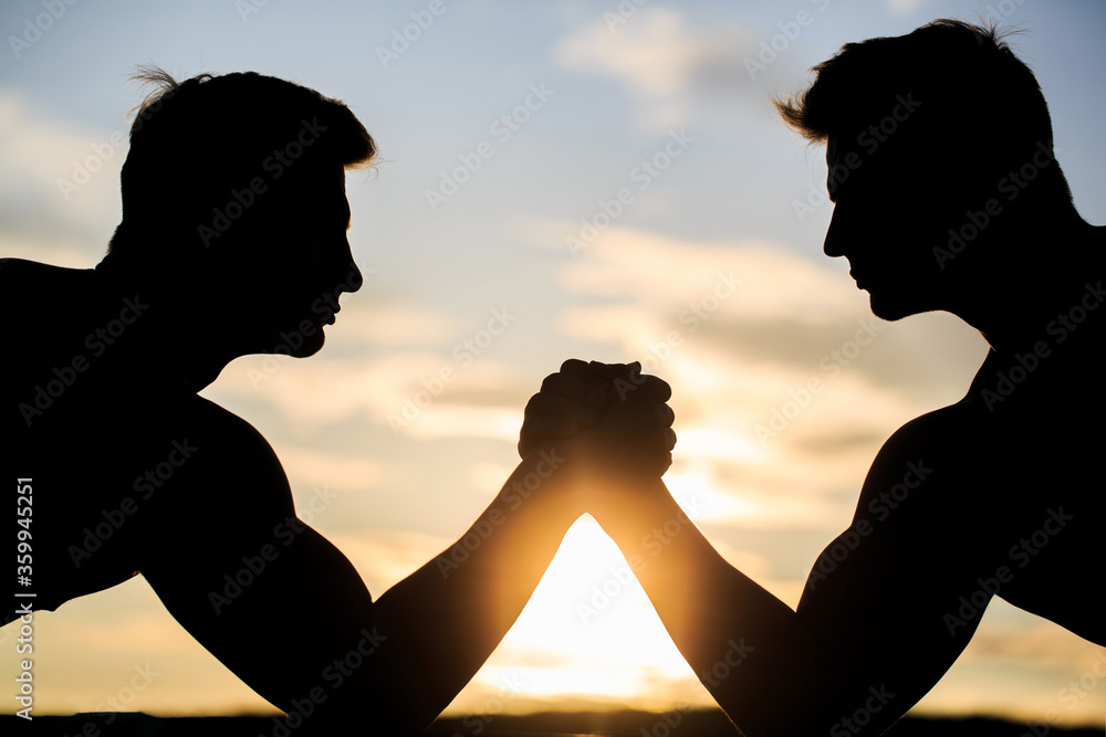 Silhouette of hands that compete in strength. Rivalry, closeup of male ...