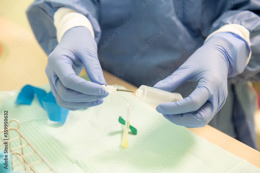 Nurse carefully prepares the material to perform a blood draw on a ...