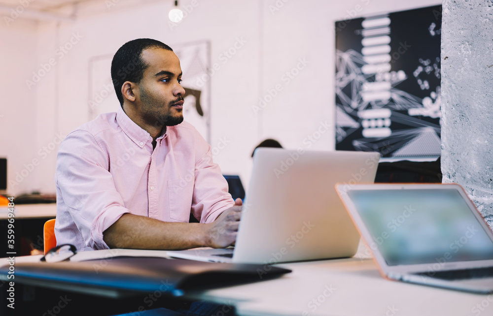 Thoughtful handsome professional IT programmer thinking about new ...