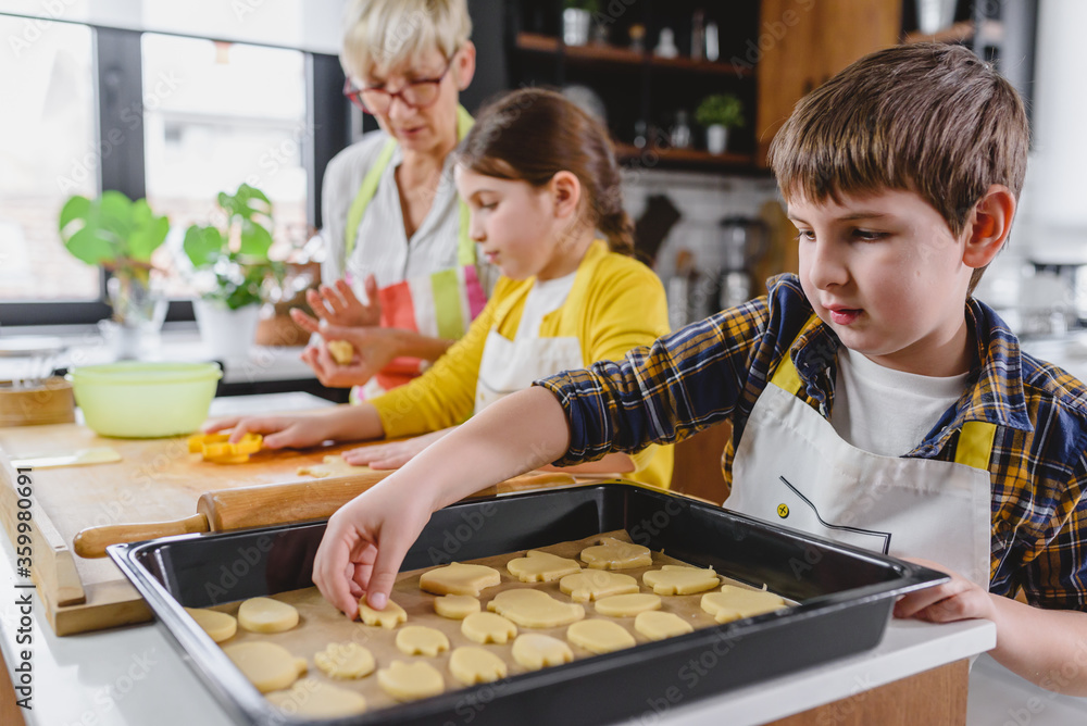 Grandmother baking cookies with her grandchildren at home. Baking ...