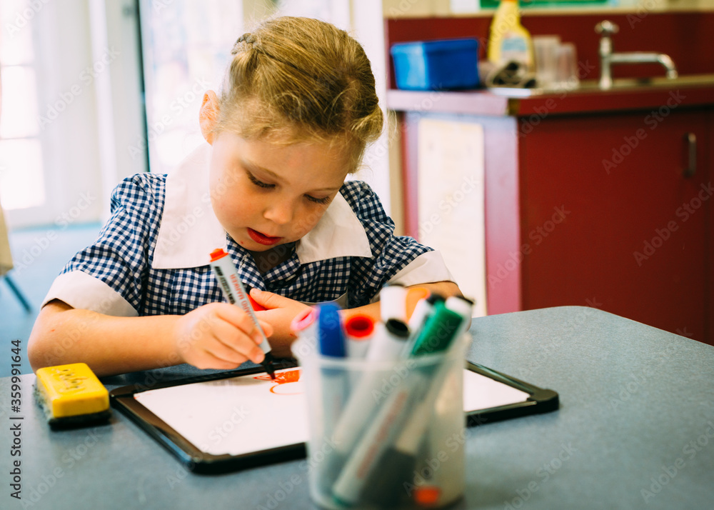 Little girl drawing in the classroom Stock Photo | Adobe Stock