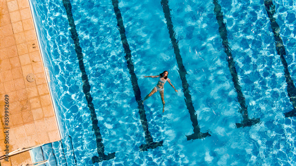 Girl floating in swimming pool Stock Photo | Adobe Stock