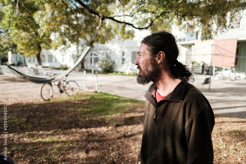 Profile of Man with Long Hair in his Backyard Stock Photo | Adobe Stock