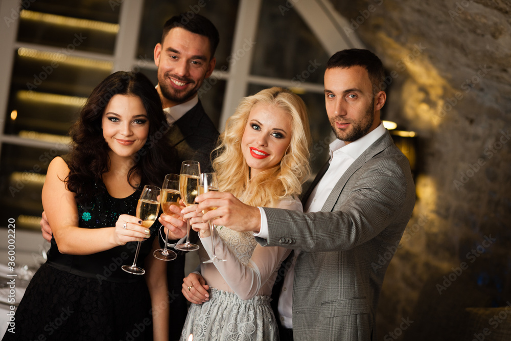 Party, holiday with friends concept. Four people with champagne glasses ...