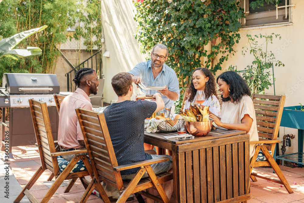 Host Serves Guests Stock Photo | Adobe Stock