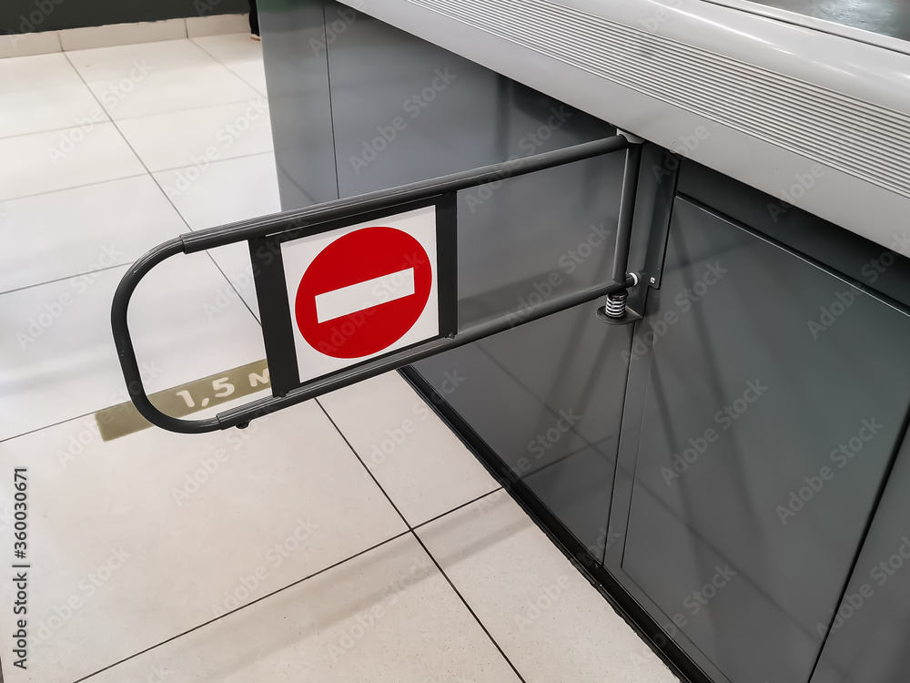 The closed barrier at the checkout counter of the supermarket with the ...