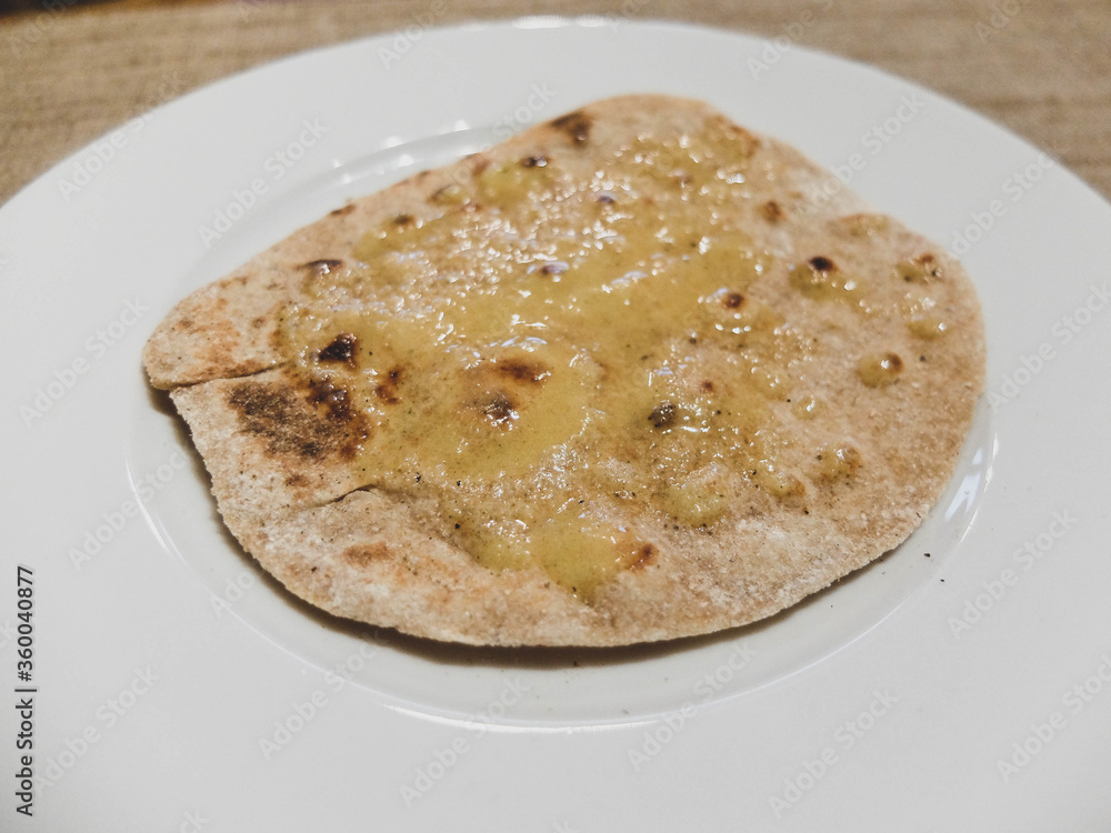 Indian homemade chapati with ghee. Chapati is a flat bread from India ...