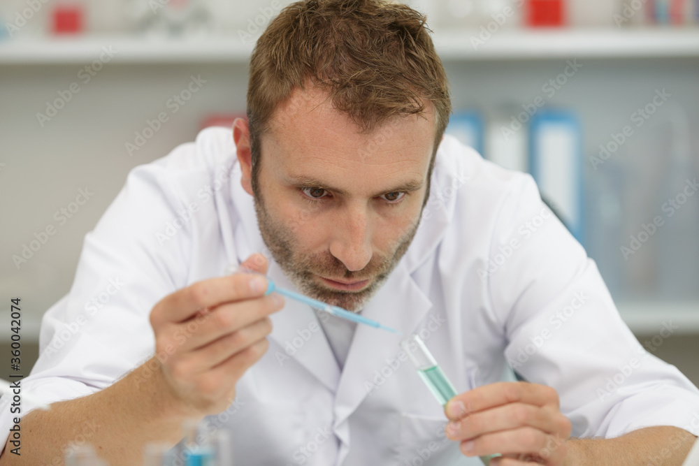 professional male laboratorian working with pipette Stock Photo | Adobe ...