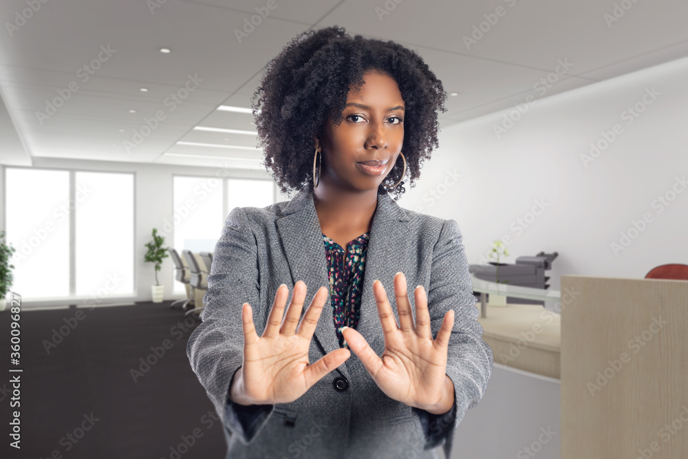 Businesswoman holding hands up as a stop gesture to tell co-workers to ...