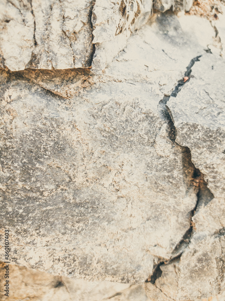 Natural background. Closeup edged shabby cliff cracks. Gray-brown stone ...