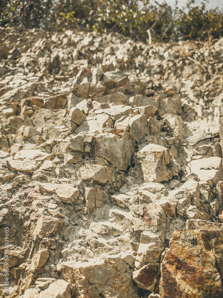 Natural background. Closeup edged shabby cliff cracks. Gray-brown stone ...