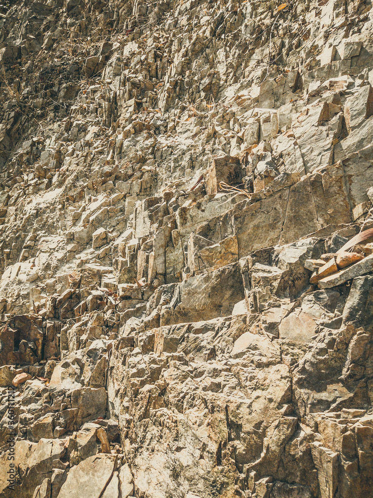 Natural background. Closeup edged shabby cliff cracks. Gray-brown stone ...