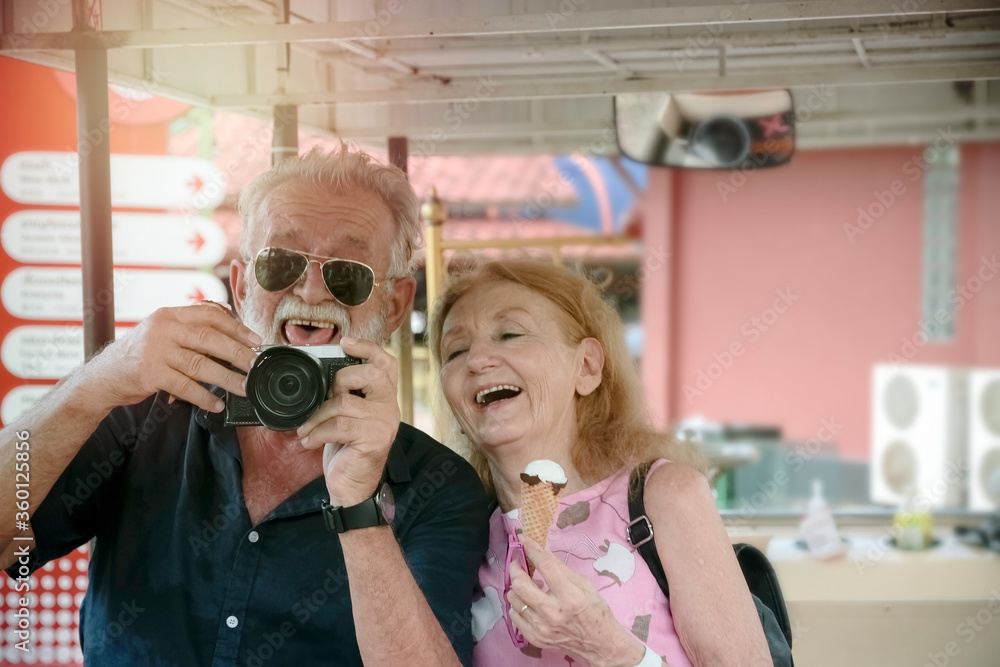 Elderly couple spending time together at theme park on summer weekend ...