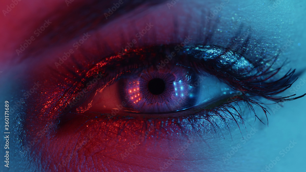 Extreme close up of human eye iris under neon light. Female with ...