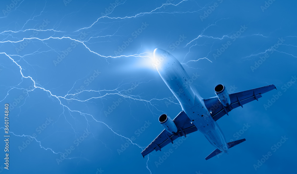 Airplane in the sky with thunder and lightning Stock Photo | Adobe Stock