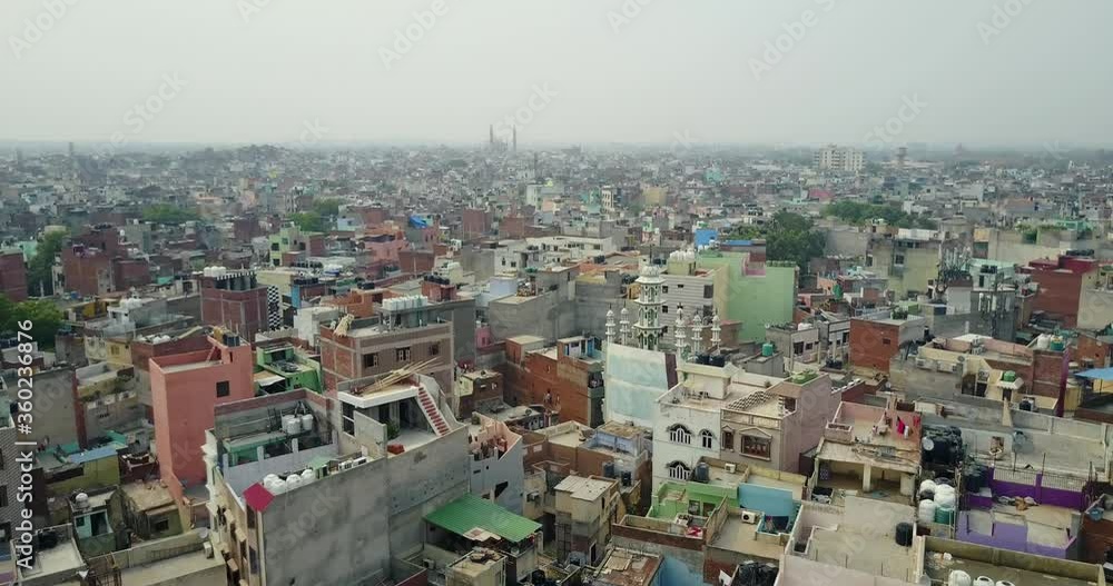 Aerial forward flying view over Old Delhi, with its rooftop, slums, old ...