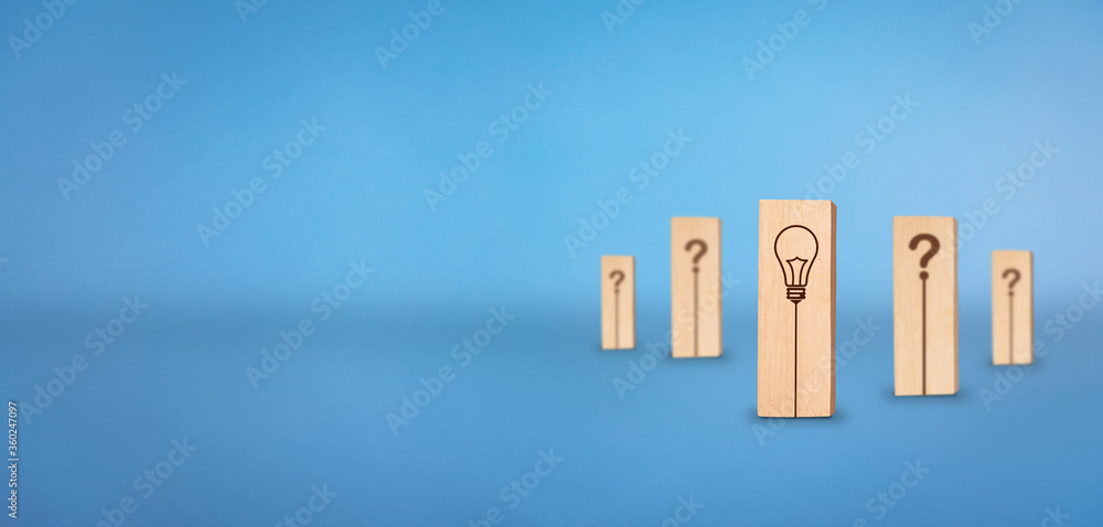 Question mark and Solution concept. Wooden block with bulb indicating ...
