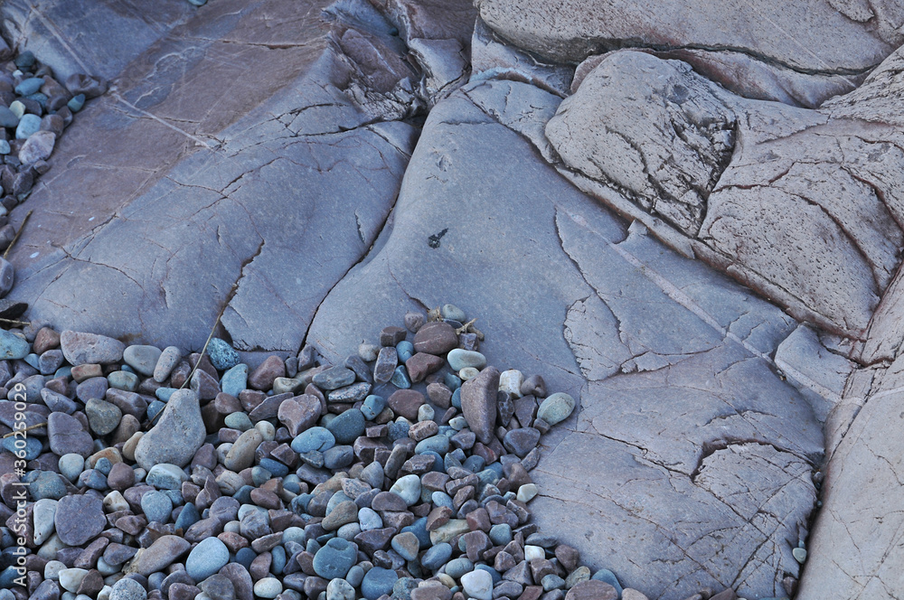 Large smooth rock with different coloured pebbles on a beach Georgian ...