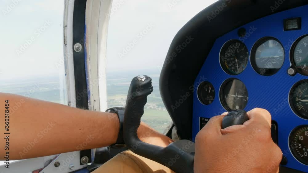 The hands of a professional pilot hold the helm and control panel of an ...
