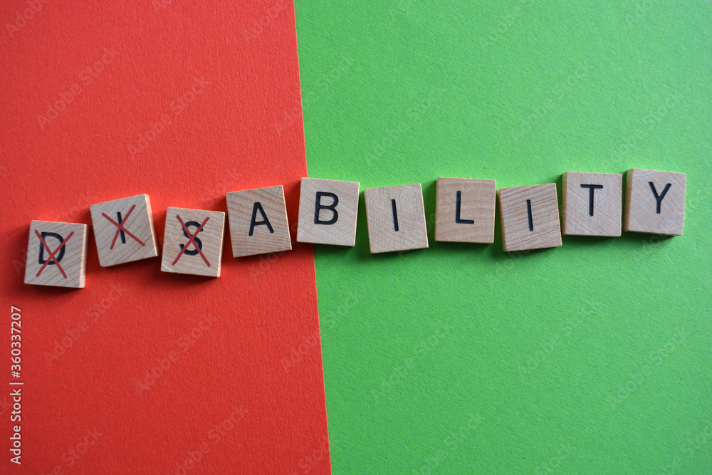 Disability, word in 3d wooden alphabet letters on a multi coloured ...