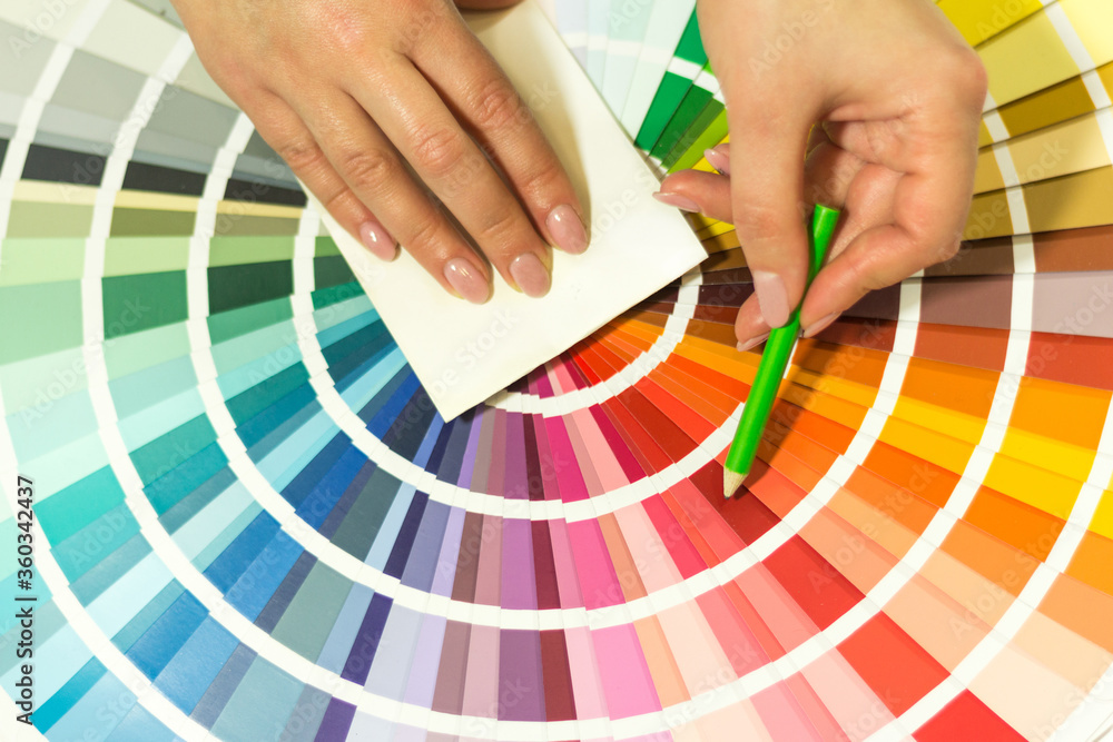 The hand of the designer shows a color palette. Catalog of rainbow ...