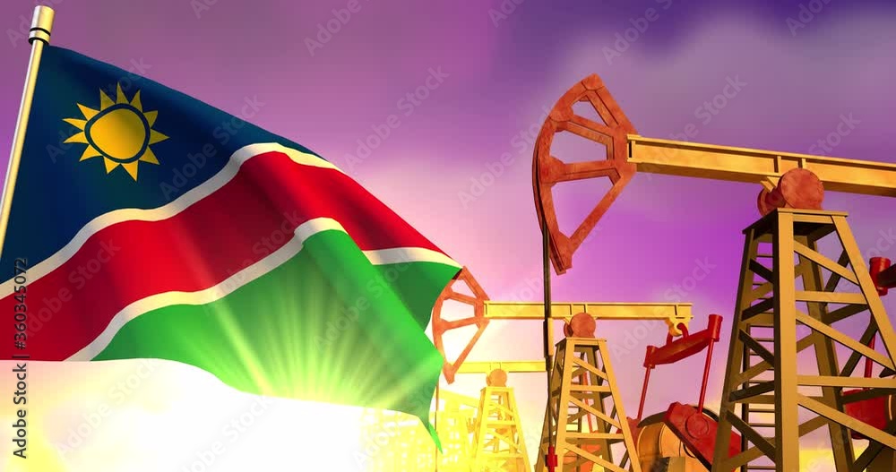 Namibia flag waving on background of oil wells pumping oil on sunset ...