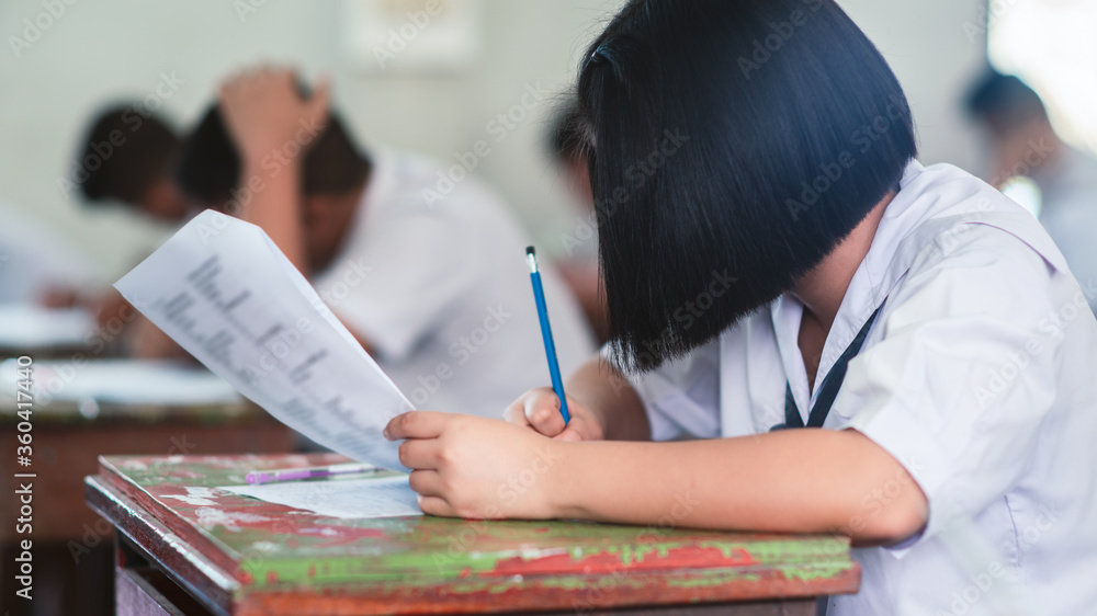 Students taking exam answer sheets exercises in classroom of school ...