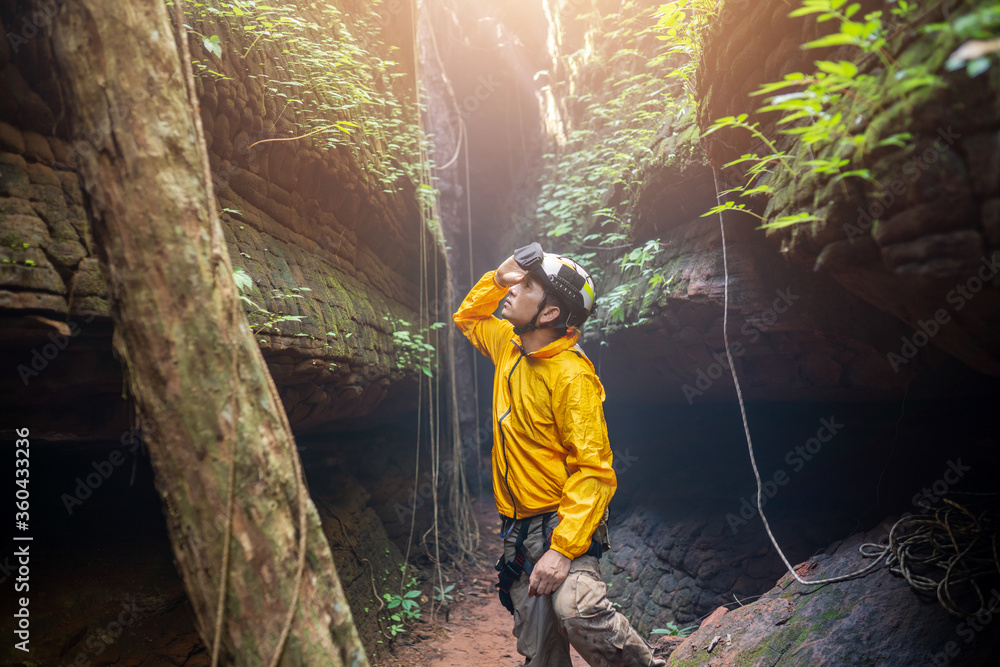Young male cave explorer or climber with rope equipment at NAKA cave in ...