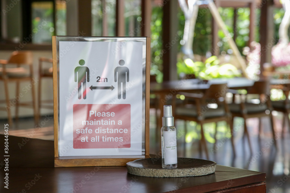 Social distancing sign at the entrance of restaurant as a reminder that ...