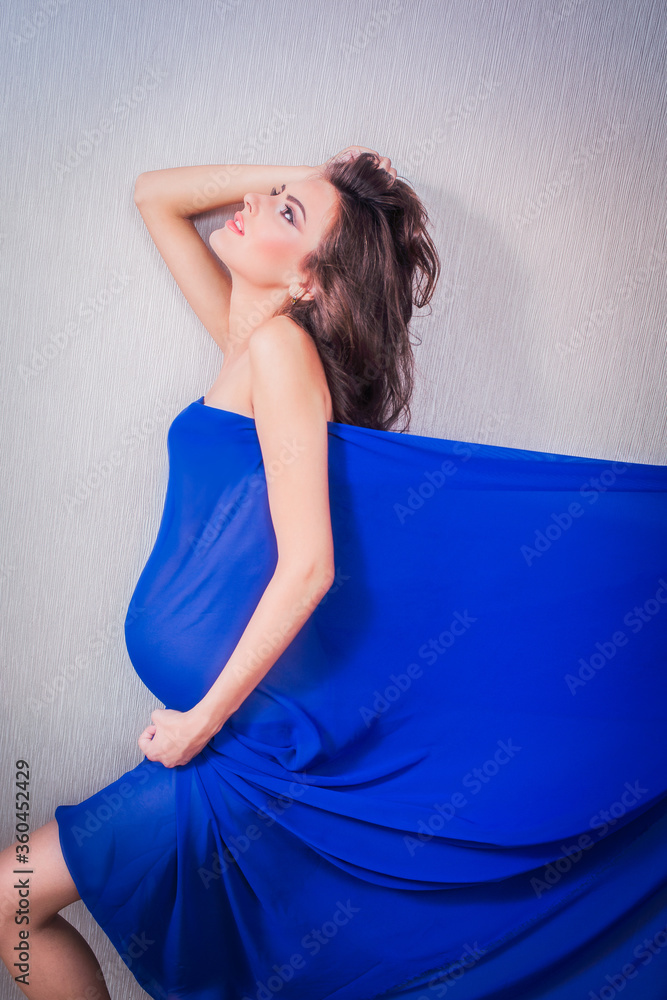 Sexy And Fit 8 Months Pregnant Woman Covered In Blue Tulle From