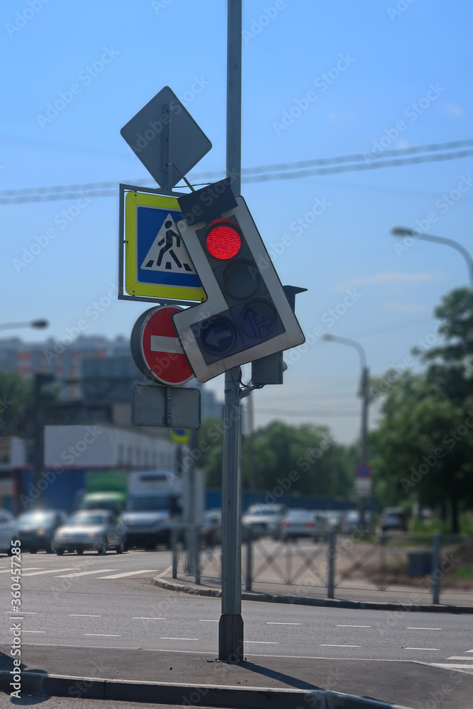 Fotografia do Stock: A pillar with traffic signs and a traffic light ...
