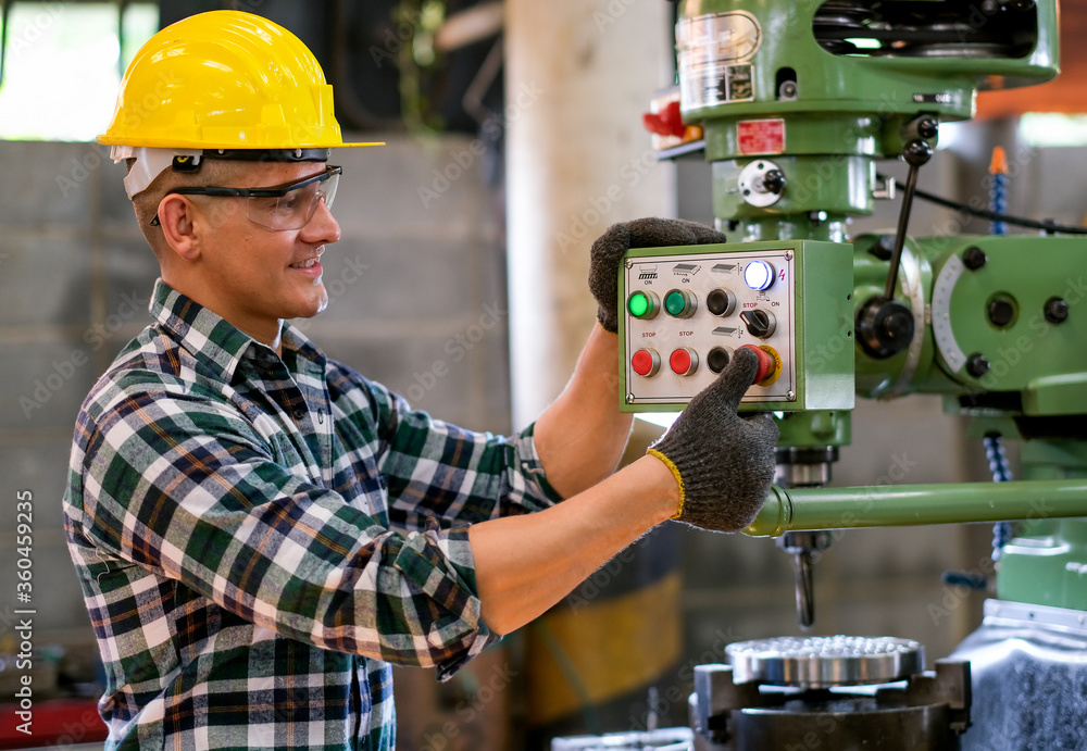 Factory worker man stand and press button of the machine to work in ...