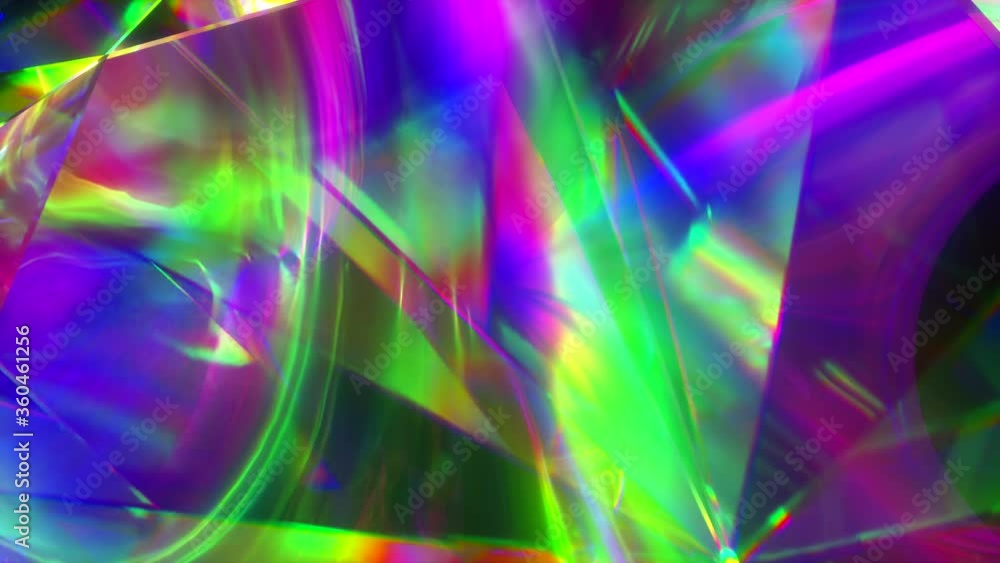 The light passes through the facets of a slowly rotating diamond and ...