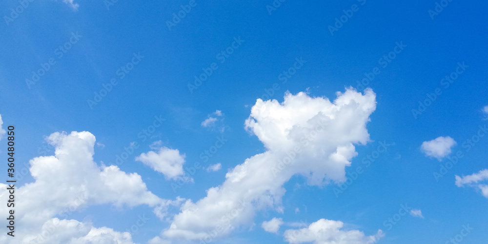An upward arrow shaped white fluffy cloud on a clear blue sunny sky ...