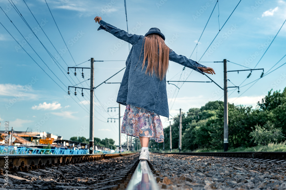 Teen girl walks by rail. Girl is walking around the rails Stock Photo ...