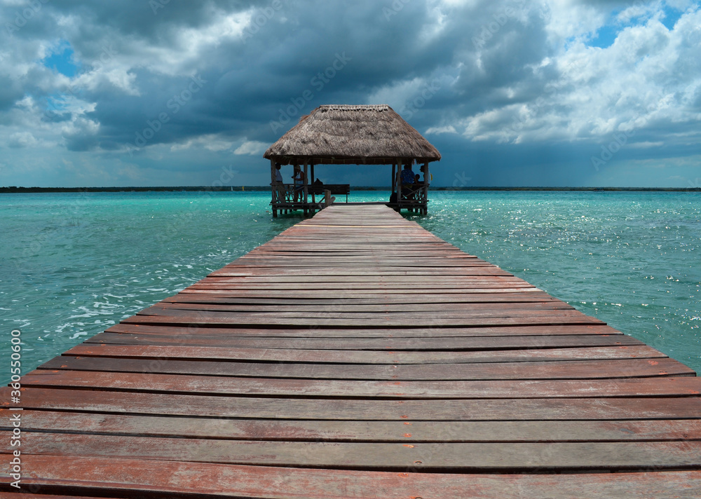 Vintage rustic wooden jetty photographed from worm eye view with water ...